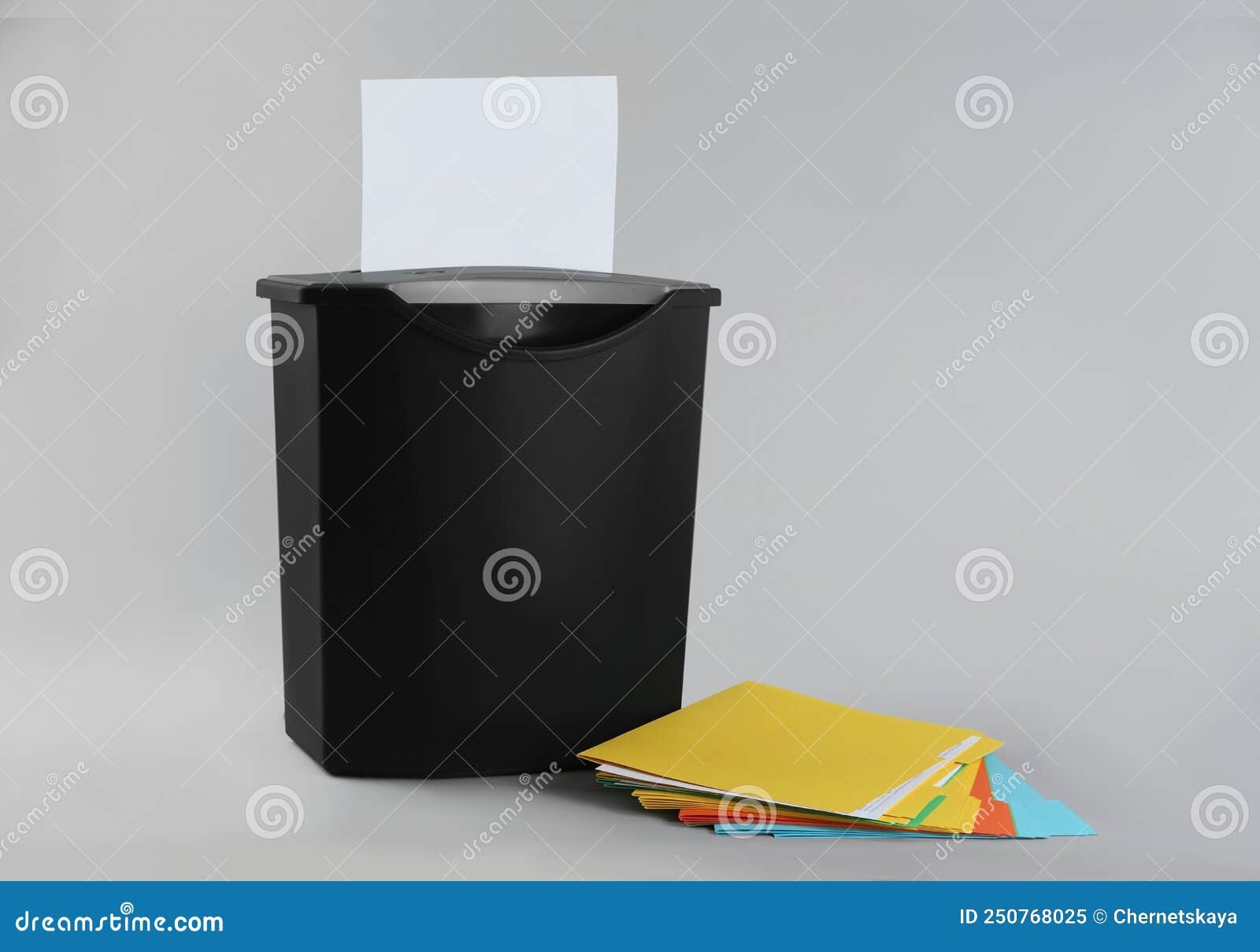 Shredder with Sheet of Paper and Colorful Folders on Grey Background ...