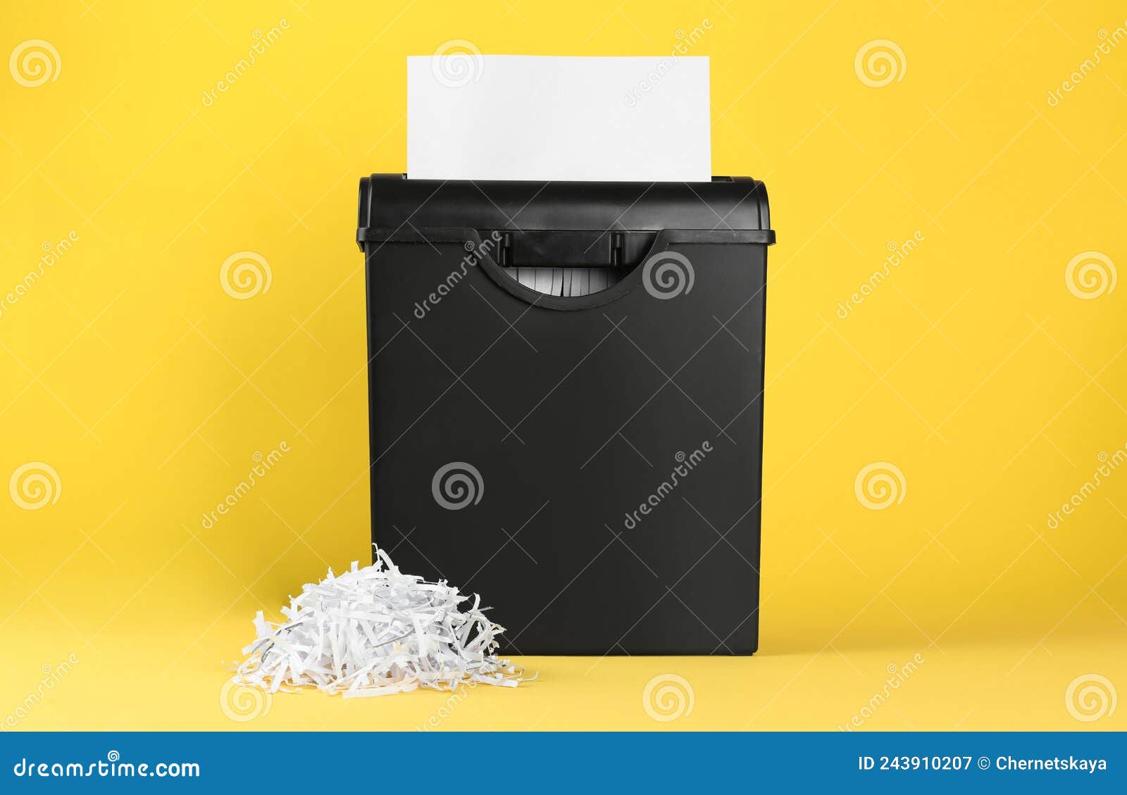 Shredder with Sheet of Paper and Strips on Yellow Background Stock ...