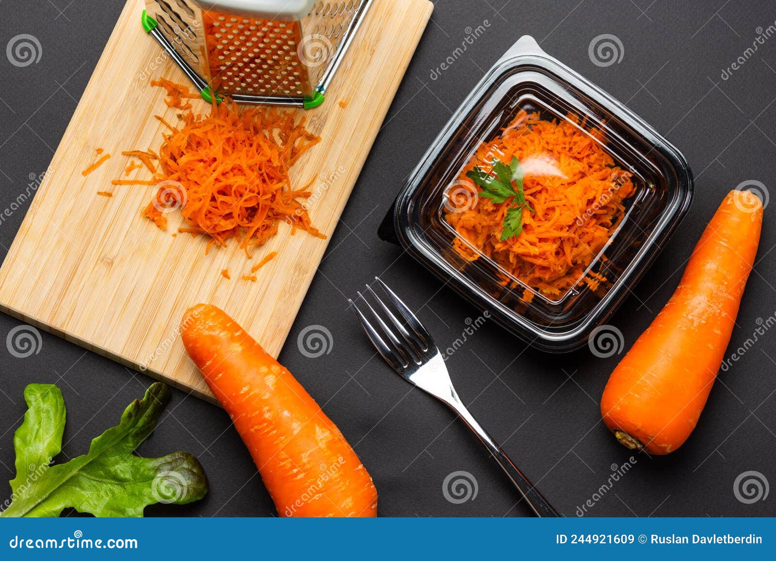 Shredding Carrots with Lunch Box Package on Black Table Background ...