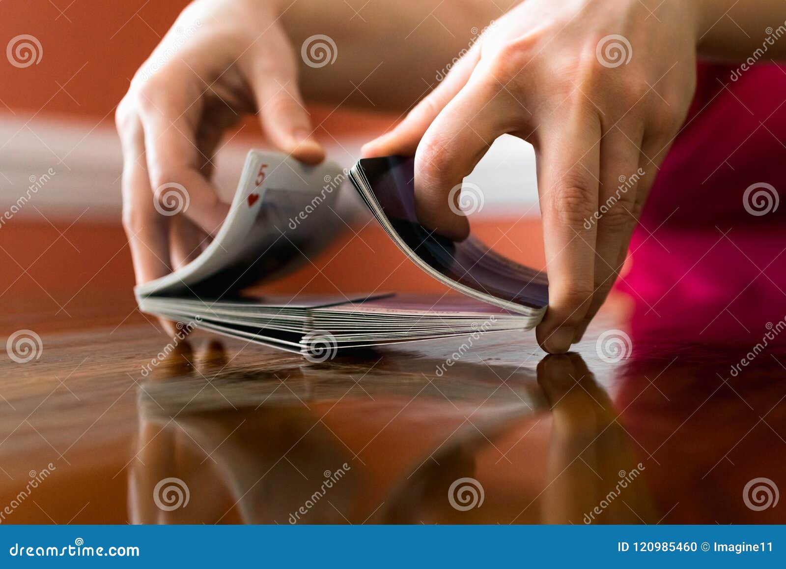 Shuffling a Deck of Cards on a Reflective Table Stock Photo - Image of ...