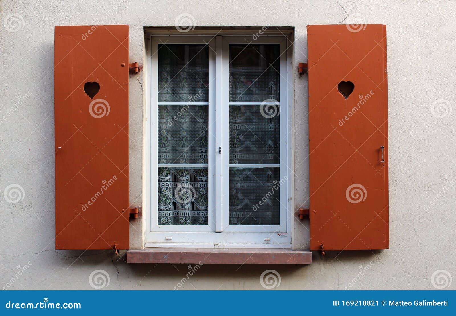 Shutter Window with Brown Doors Open on a Rural House Facade Stock ...