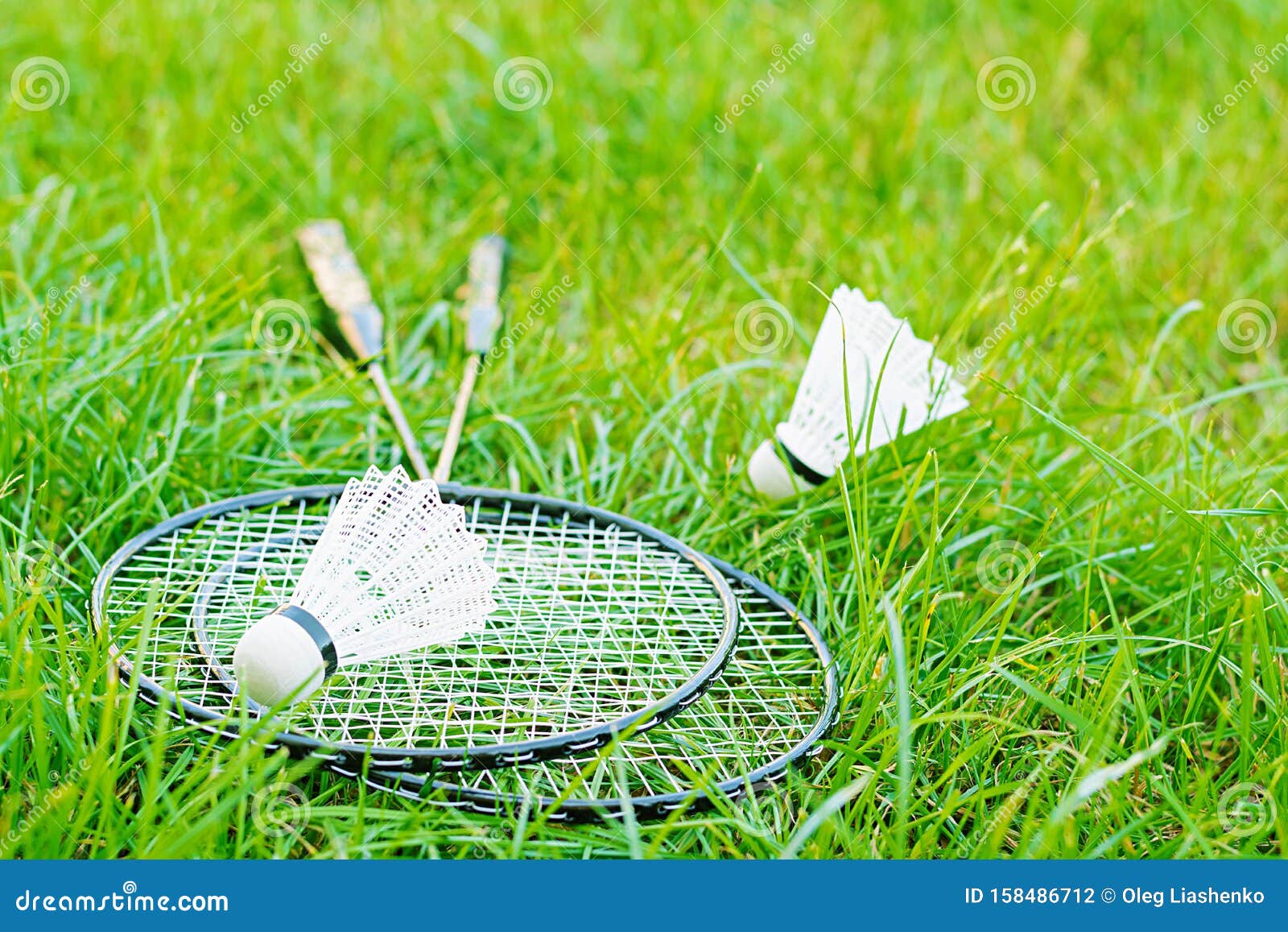Shuttlecock and Badminton Rackets on a Green Lawn Stock Photo - Image ...