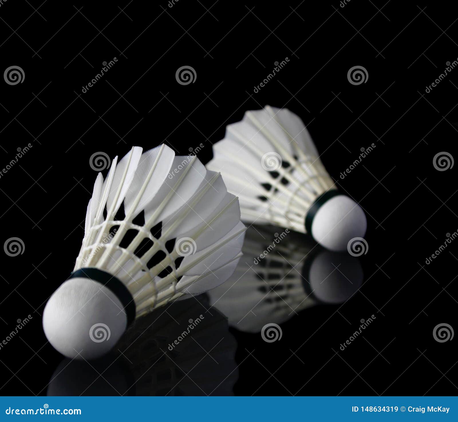 Shuttlecocks Against Black on Reflective Surface Stock Image - Image of ...