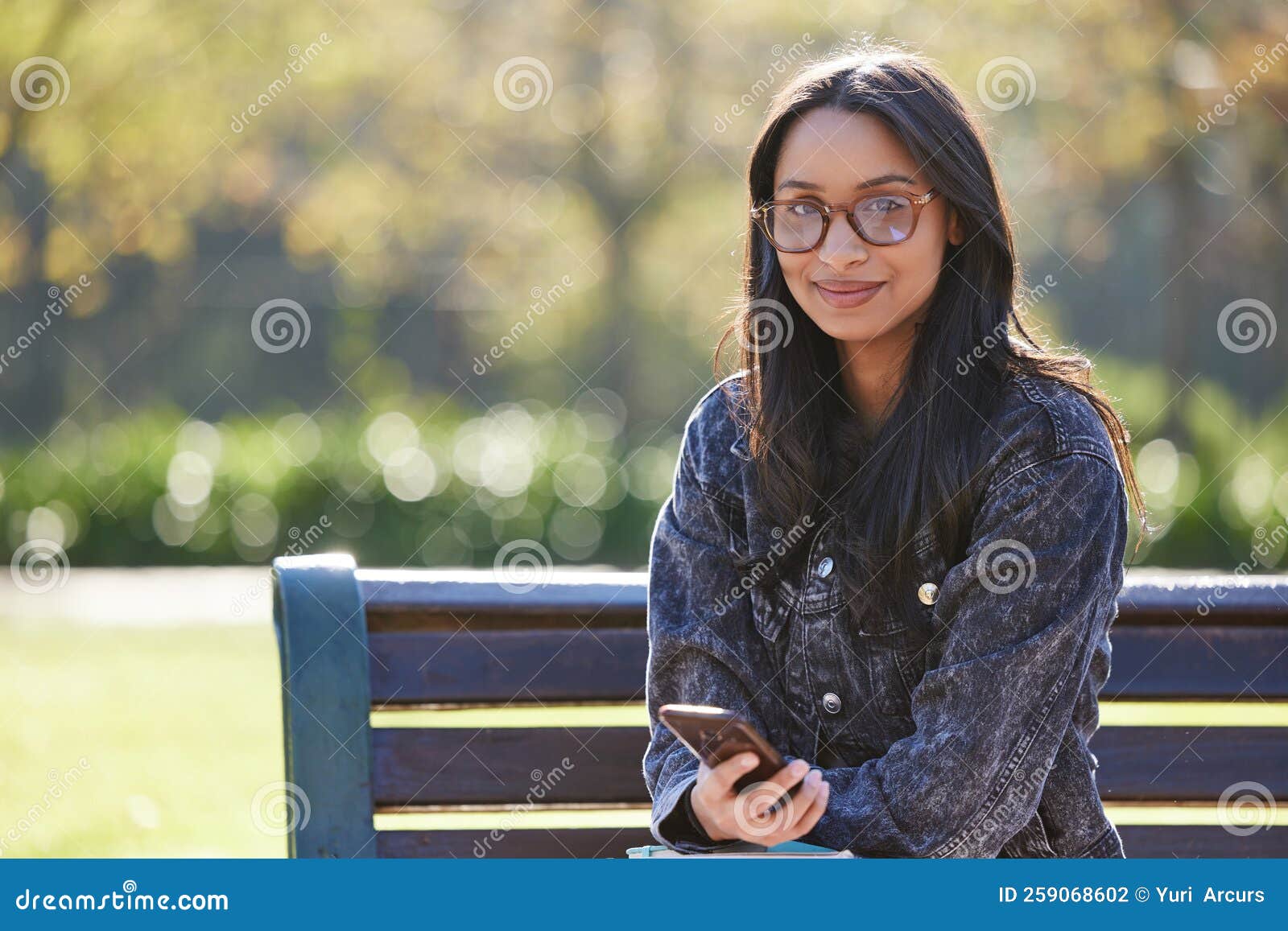Shy but Brave. a Beautiful Young Student Using Her Phone while Sitting ...