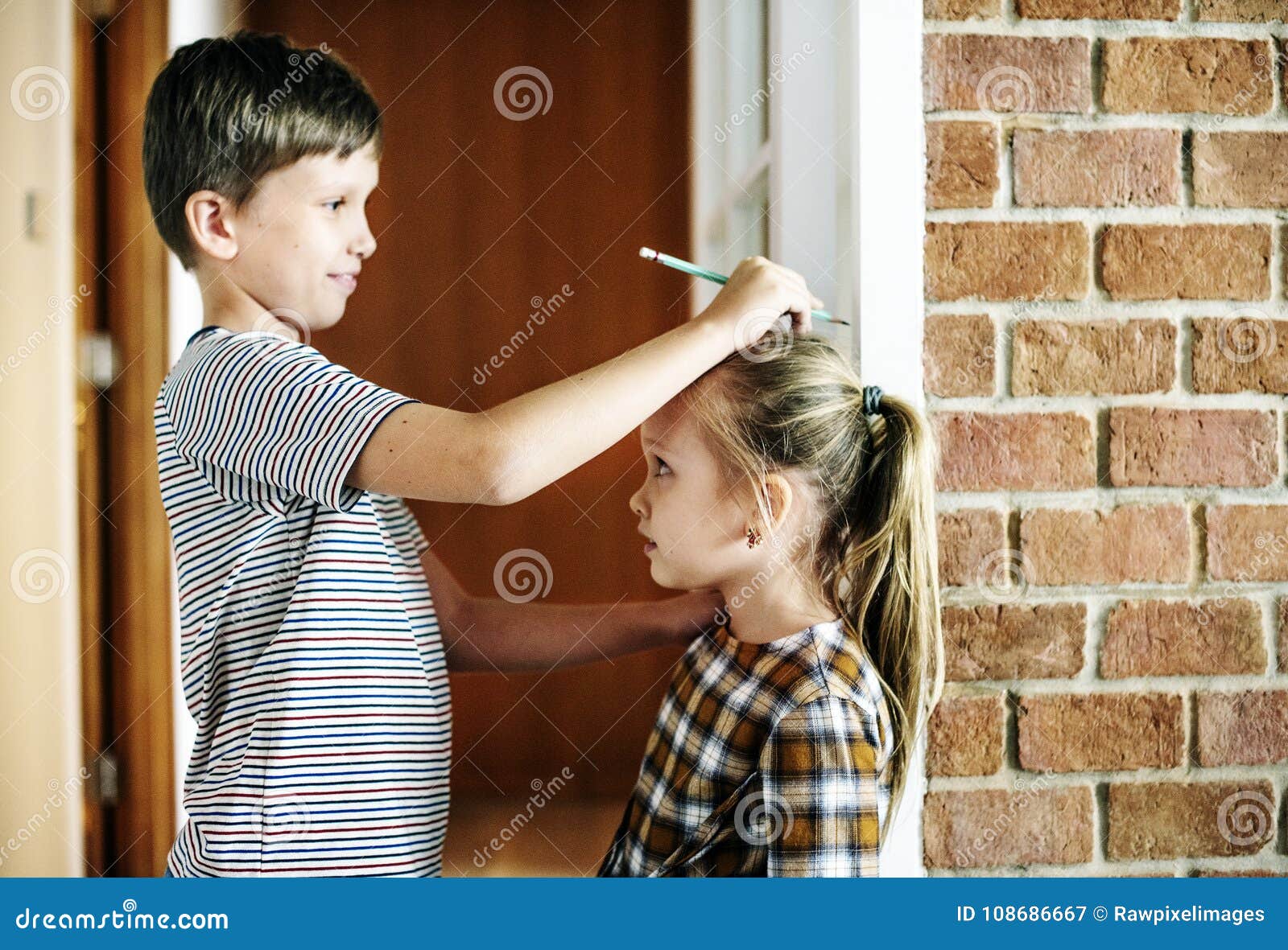 Siblings Checking Height Home Together Stock Image - Image of home ...