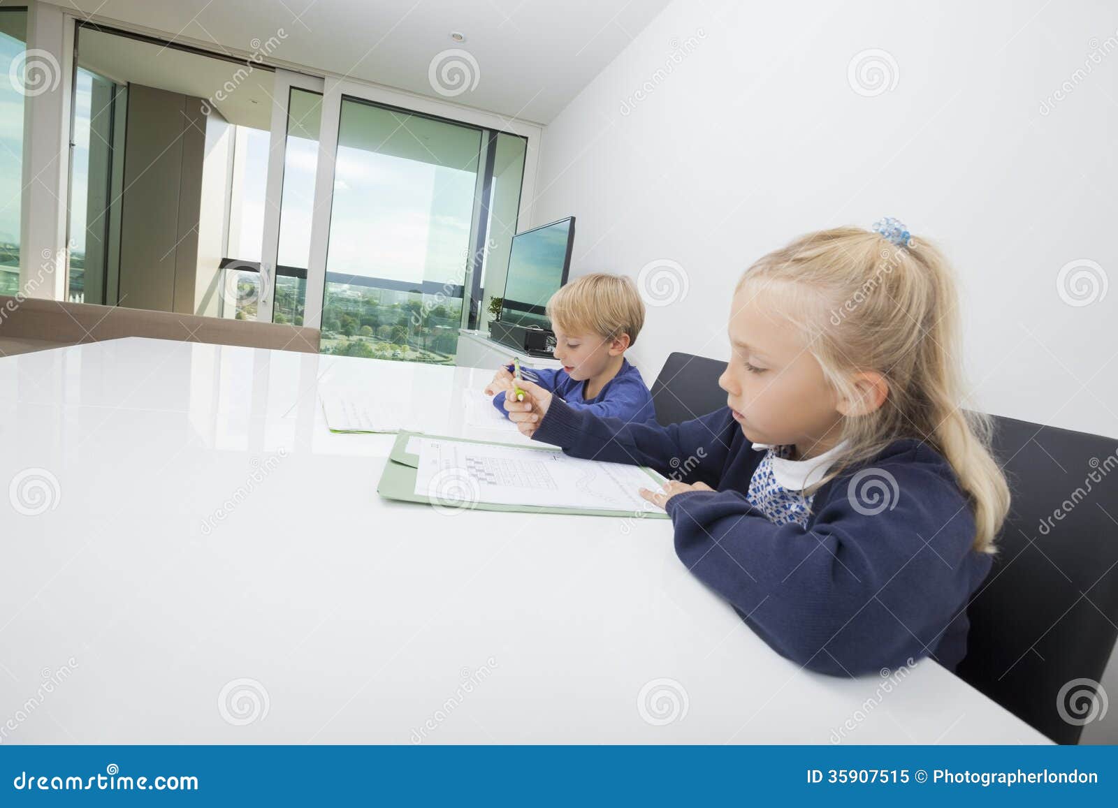 Siblings Doing Homework at Table in House Stock Image - Image of people ...