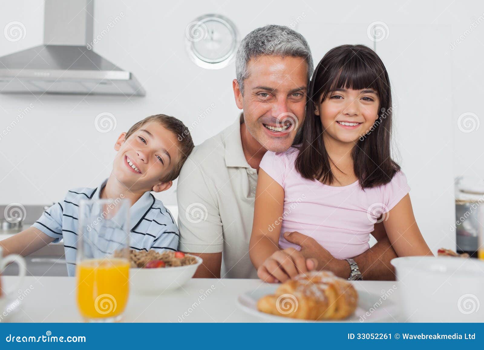 Siblings Eating Breakfast in Kitchen Together with Dad Stock Image ...