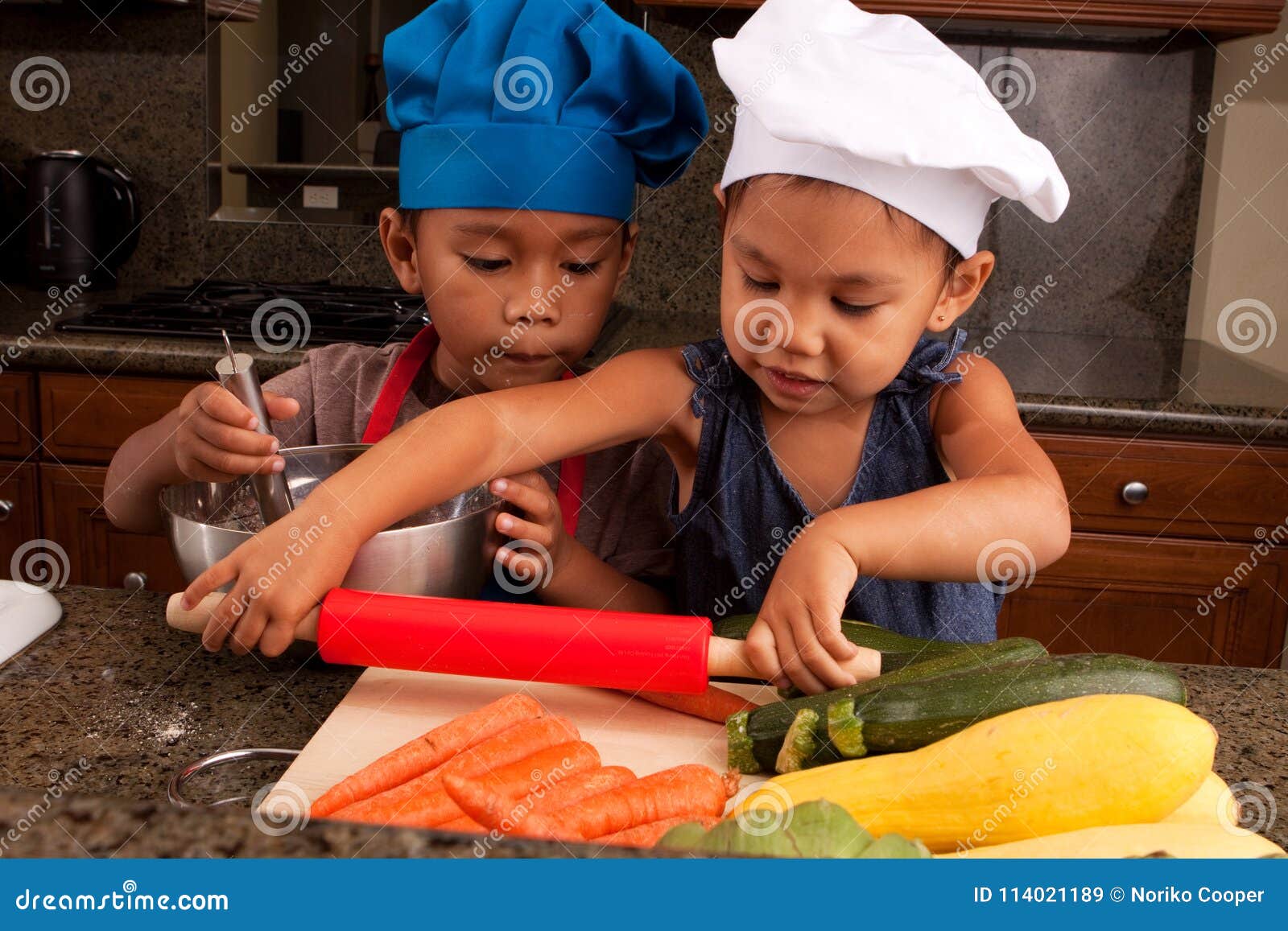 Siblings Eating and Cooking in the Kitchen. Stock Image - Image of ...