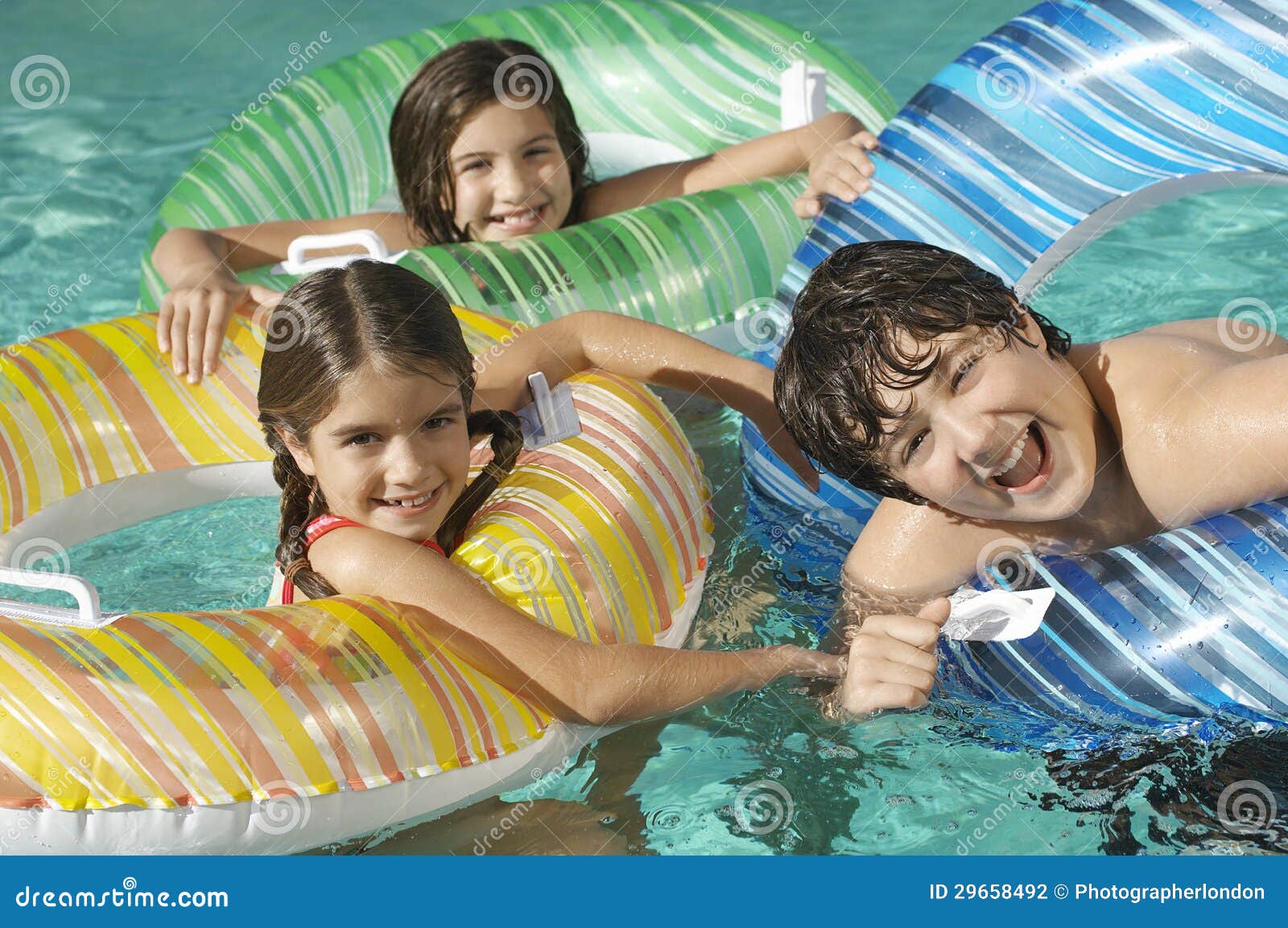 Siblings Enjoying Together in Swimming Pool Stock Photo - Image of ...