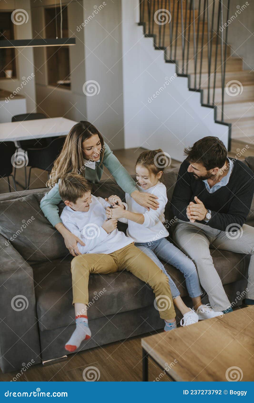 Siblings Fighting Over TV Remote Control at Home Stock Photo - Image of ...