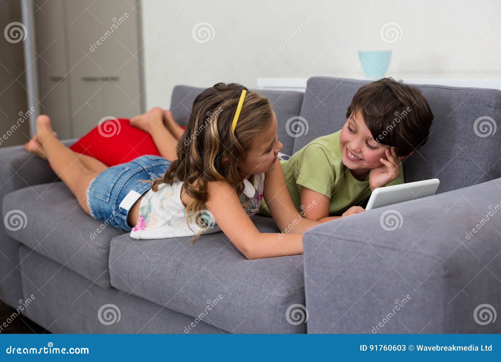 Siblings Interacting with Each Other while Using Digital Tablet Stock ...
