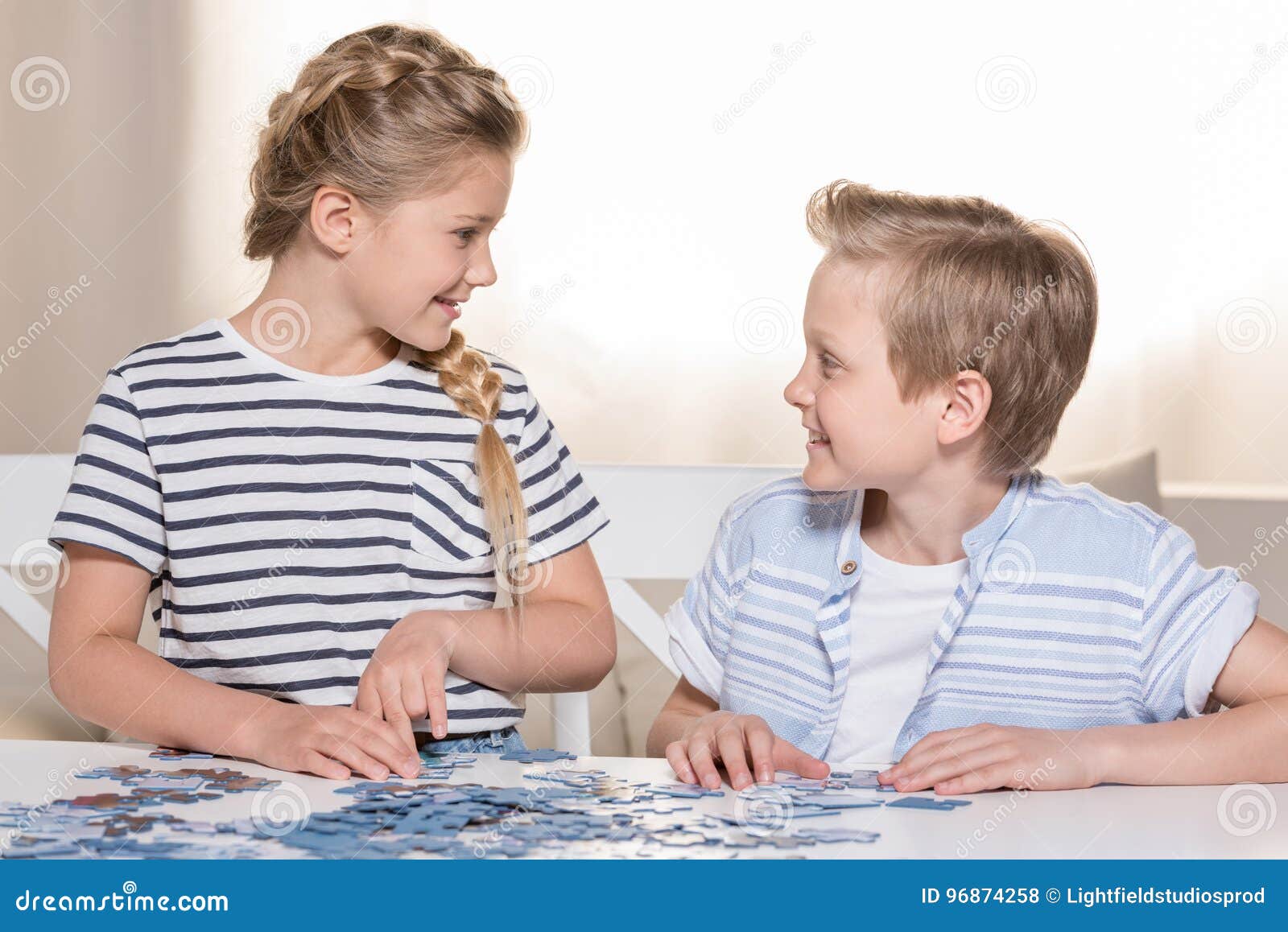 Siblings Playing with Puzzle on Table at Home Together Stock Photo ...