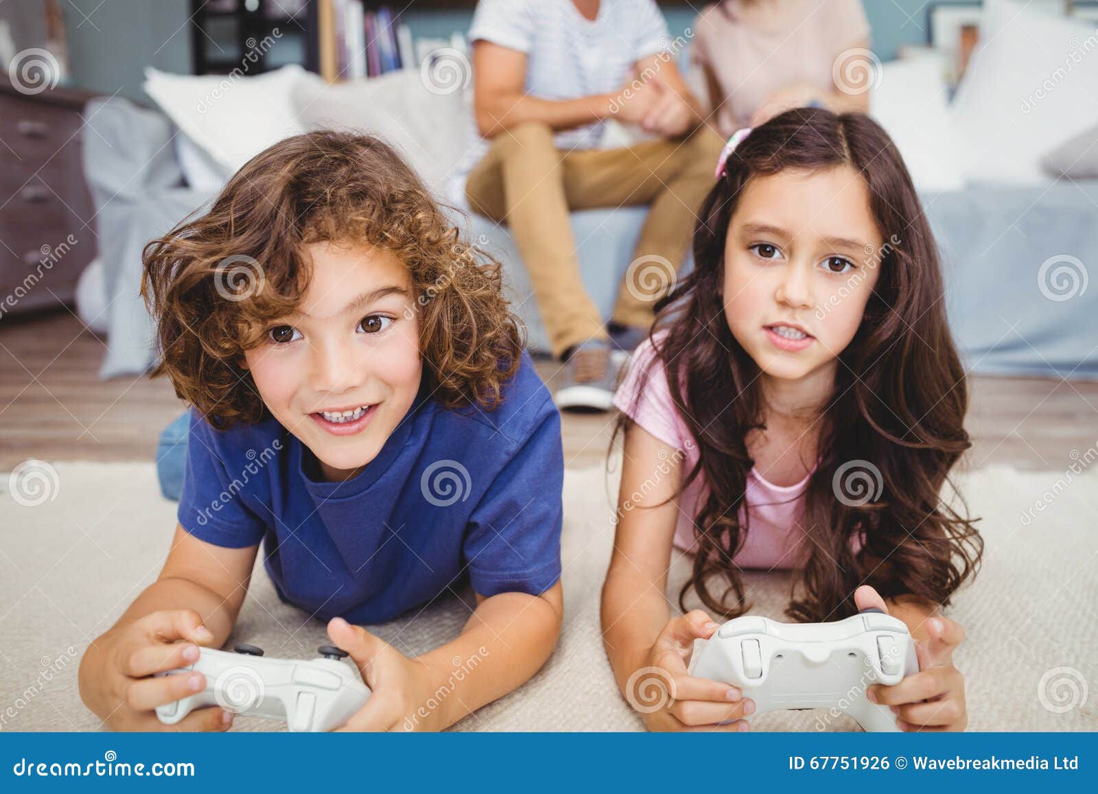 Siblings with Remote Playing Video Games on Carpet Stock Photo - Image ...