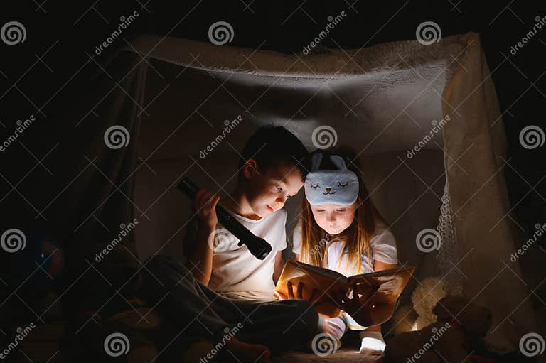 Siblings Sit In A Hut Of Chairs And Blankets Brother And Sister