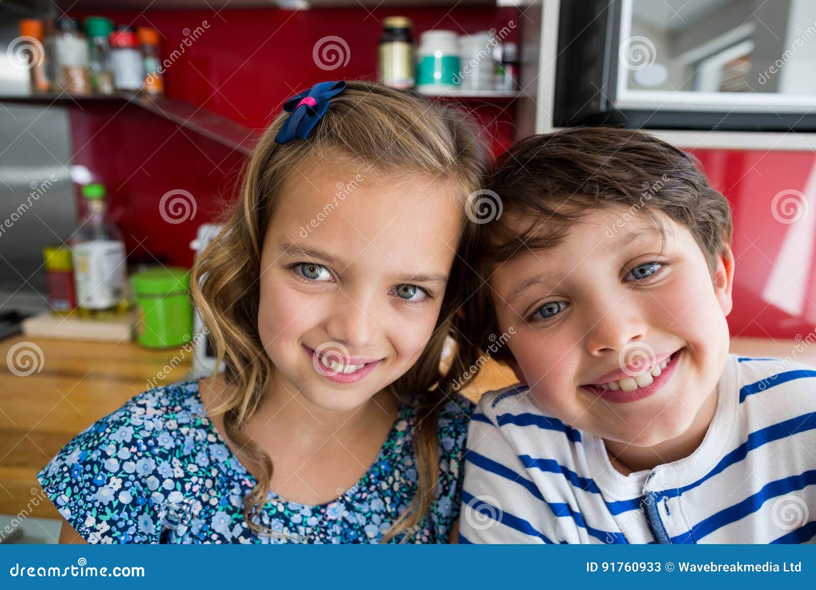 Siblings Smiling at Camera in Kitchen Stock Image - Image of casual ...