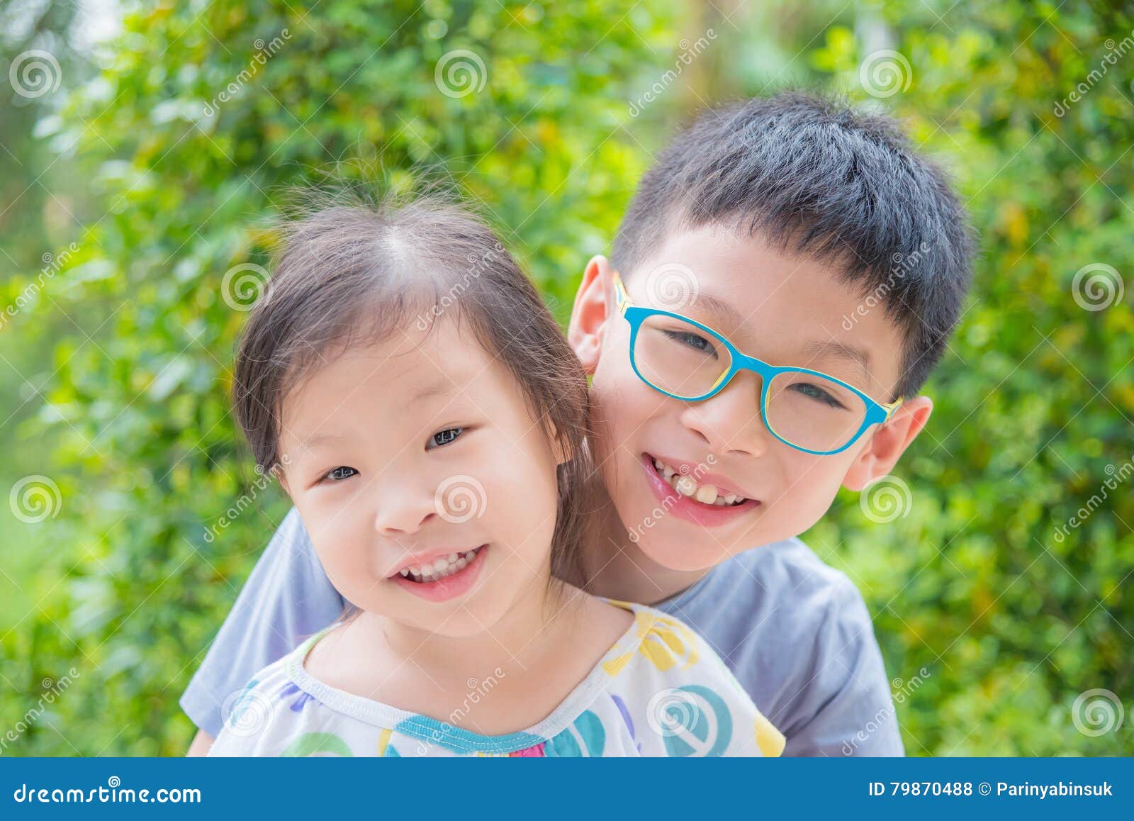 Siblings smiling in park stock photo. Image of children - 79870488