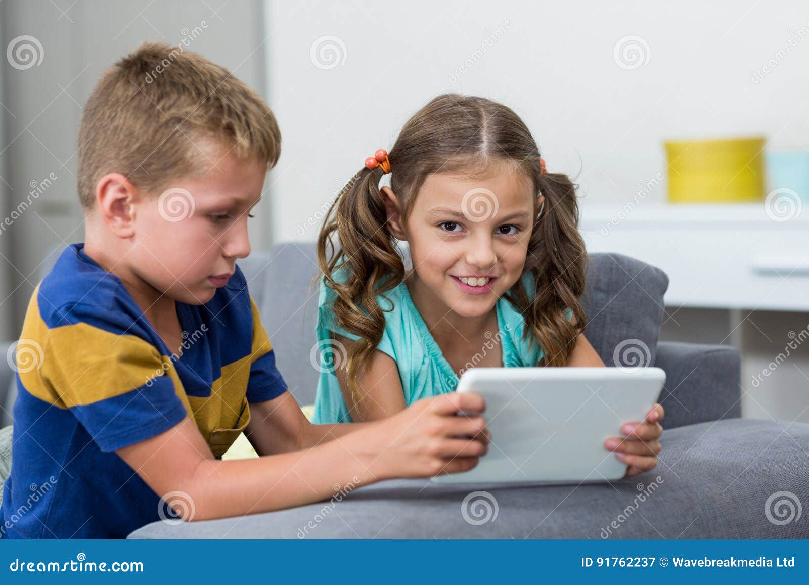 Siblings Using Digital Tablet in Living Room Stock Image - Image of ...