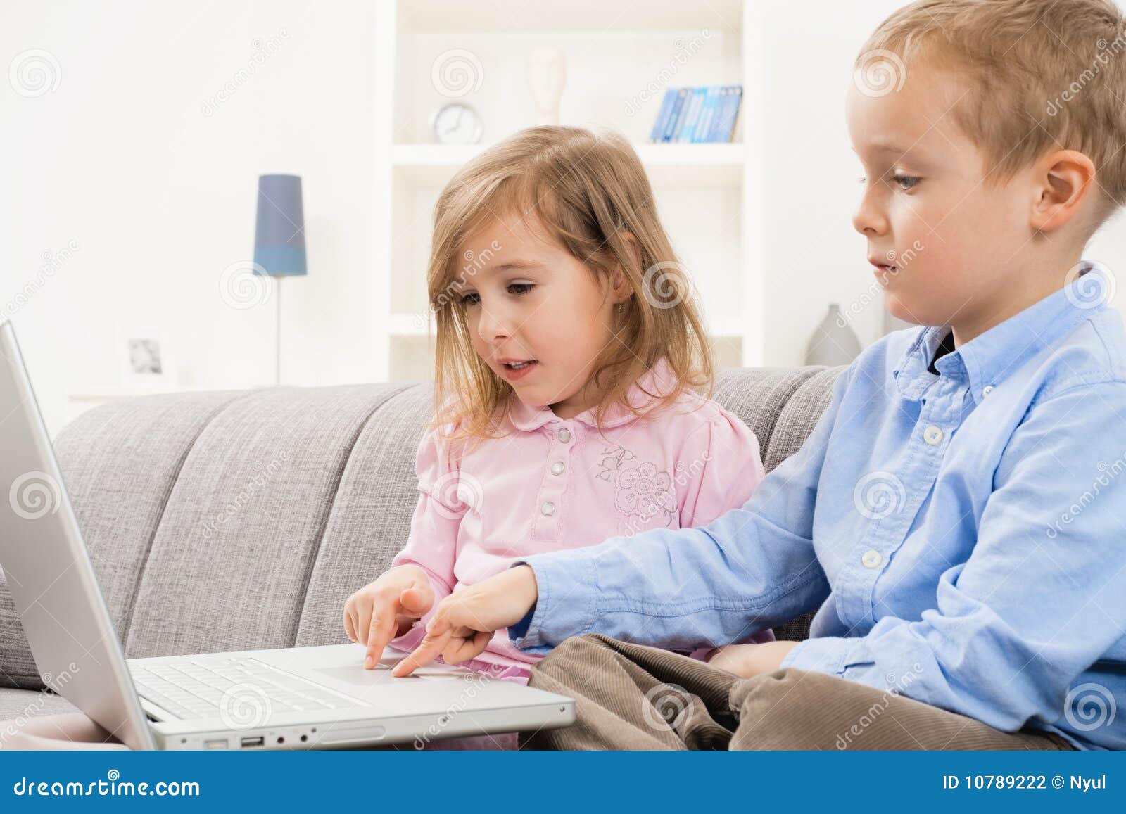 Siblings Using Laptop Computer Stock Photo - Image of color, browsing ...