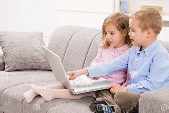 Siblings Using Laptop Computer Stock Photo - Image of brother, grey ...