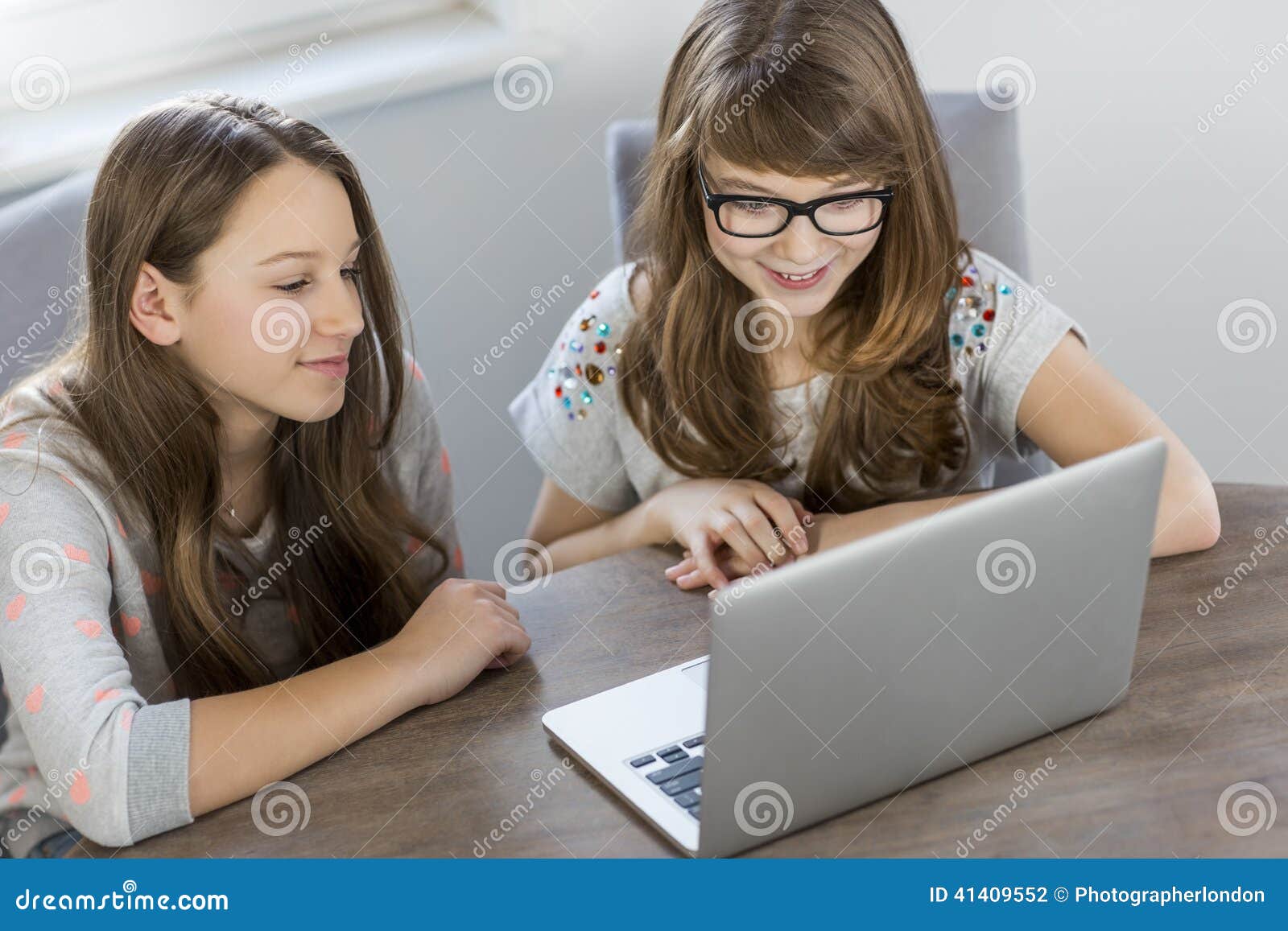 Siblings Using Laptop Together at Home Stock Photo - Image of looking ...