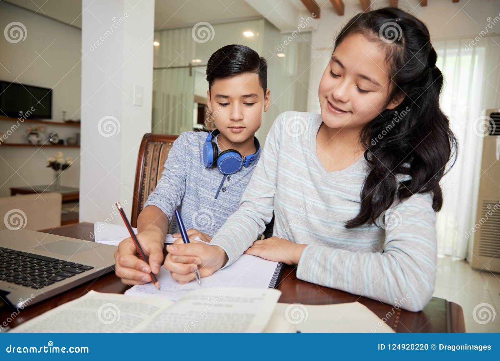 Siblings writing essay stock photo. Image of vietnamese - 124920220