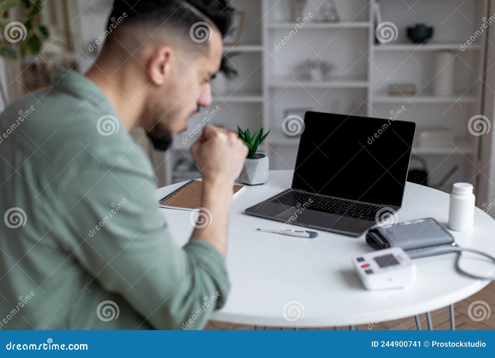 Sick Arab Man Using Laptop Computer While Sitting In Bed At Home Stock ...