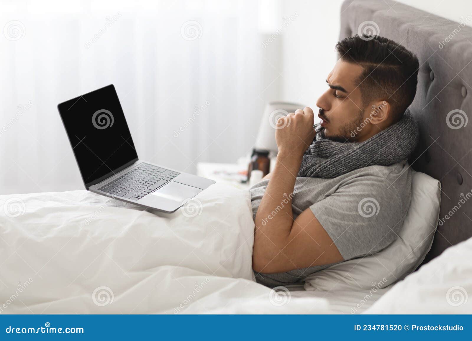 Sick Arab Man Using Laptop Computer while Sitting in Bed at Home Stock ...