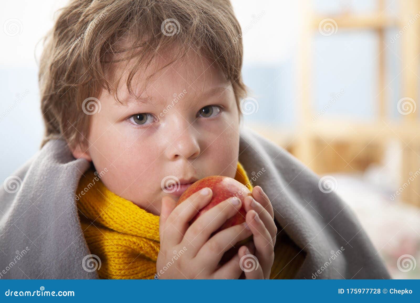 Sick Boy in Warm Clothes Holding Fruit at Home Stock Photo - Image of ...