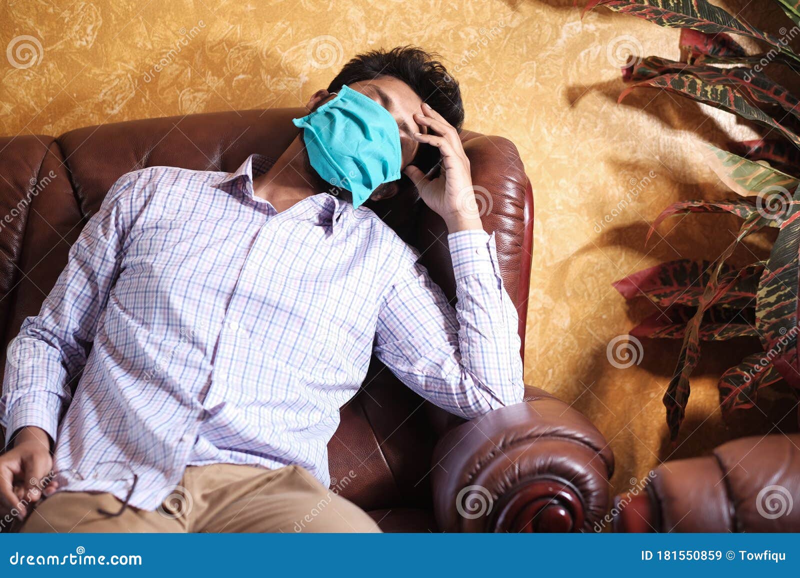 A Sick Man with a Mask on His Face Resting on Sofa Stock Image - Image ...