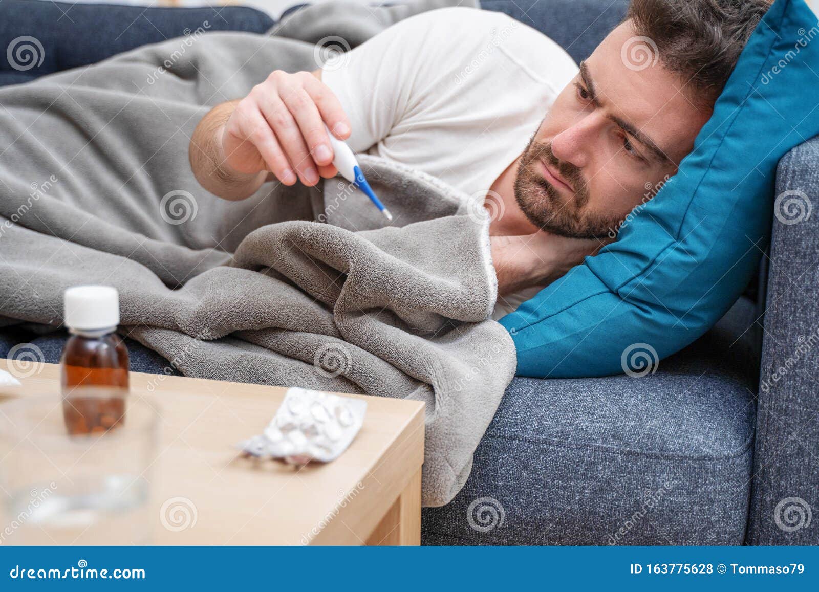 Sick Man Portrait on the Sofa Checking Fever Temperature Stock Photo ...