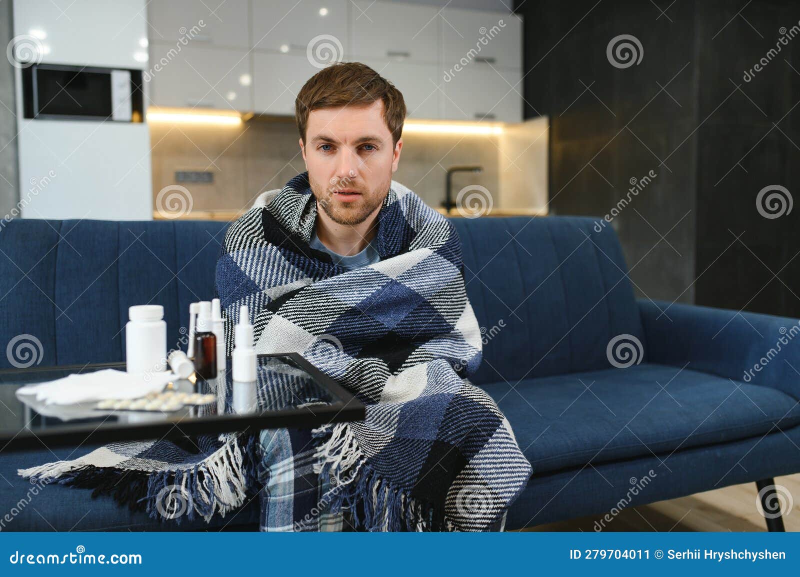 Sick man on sofa at home. stock image. Image of pain - 279704011