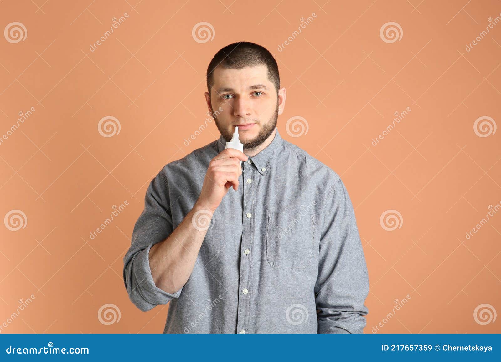 Sick Man Using Nasal Spray on Orange Background Stock Image - Image of ...