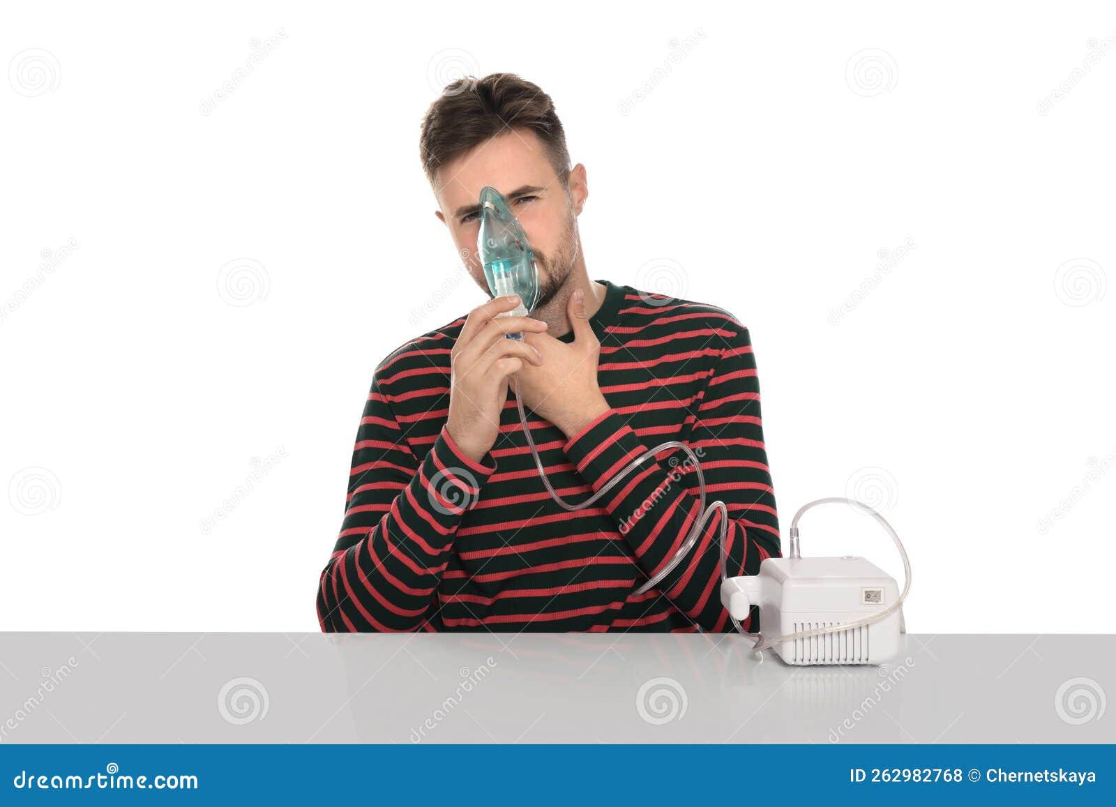 Sick Man Using Nebulizer for Inhalation at Table on White Background ...