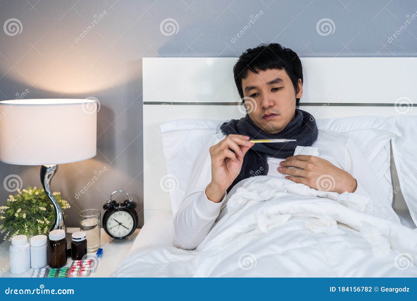 Sick Man Using Thermometer To Checking His Temperature in Bed Stock ...