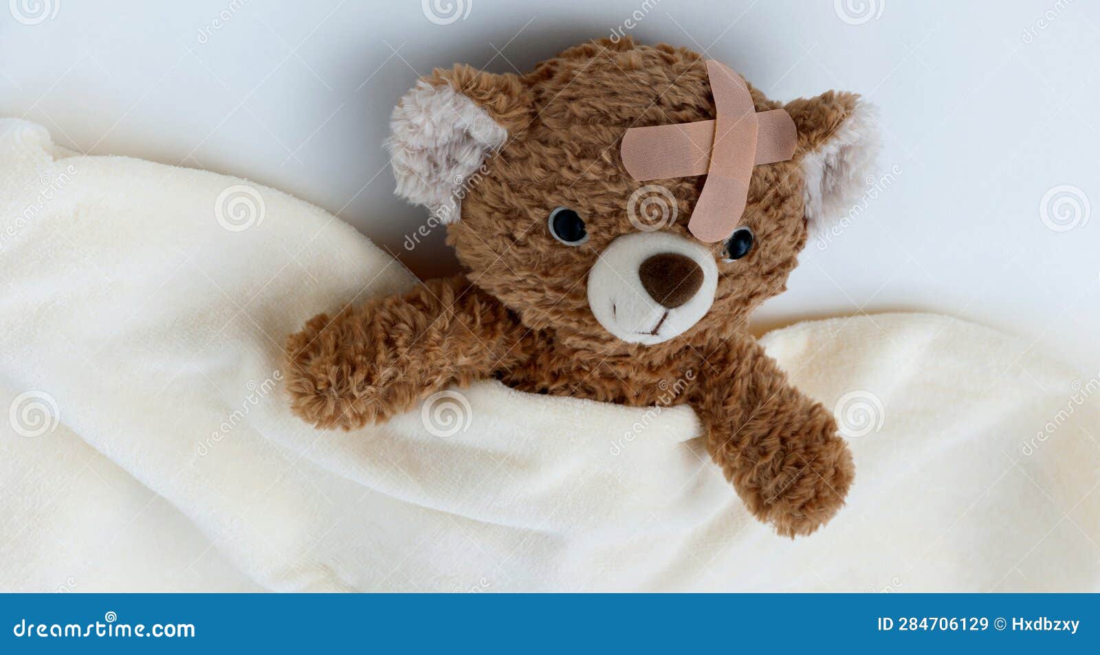 Sick Teddy Bear Toy with Patch on Head Lying in Bed Stock Image - Image ...