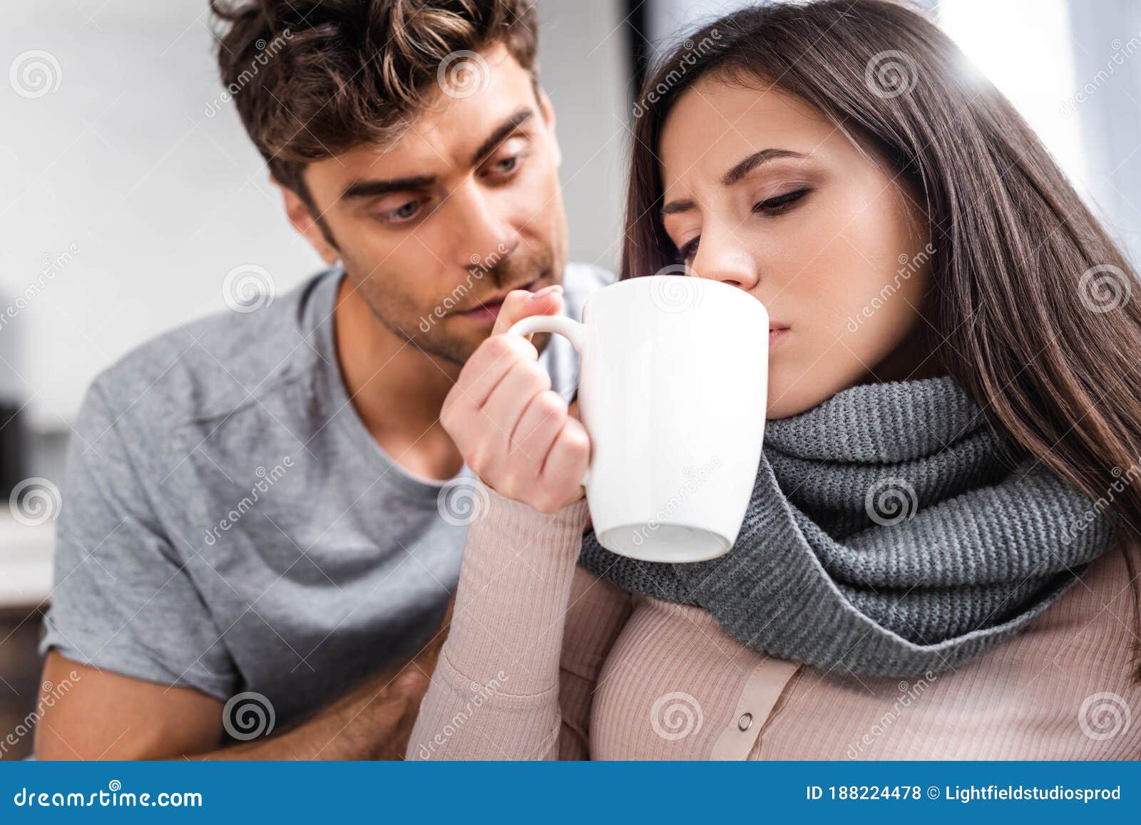 Sick Woman Drinking Tea and Man Looking at Her Stock Photo - Image of ...