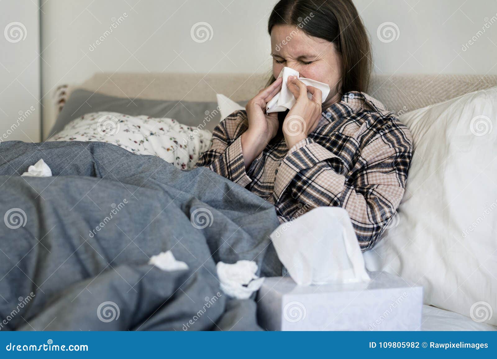 Sick woman sneezing in bed stock photo. Image of medical - 109805982