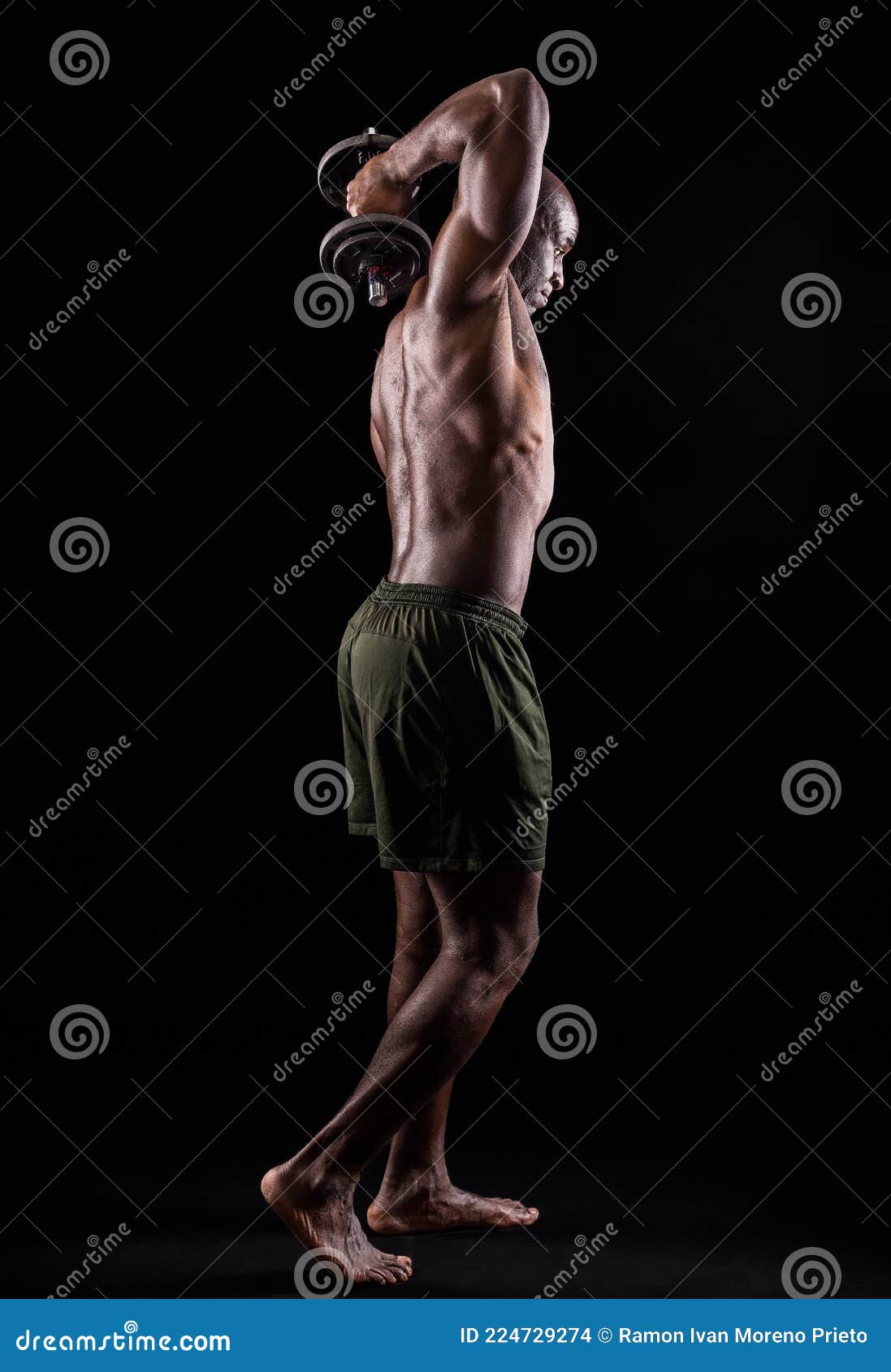Side Back View of a Muscular Man Standing Doing Triceps Exercise Stock ...