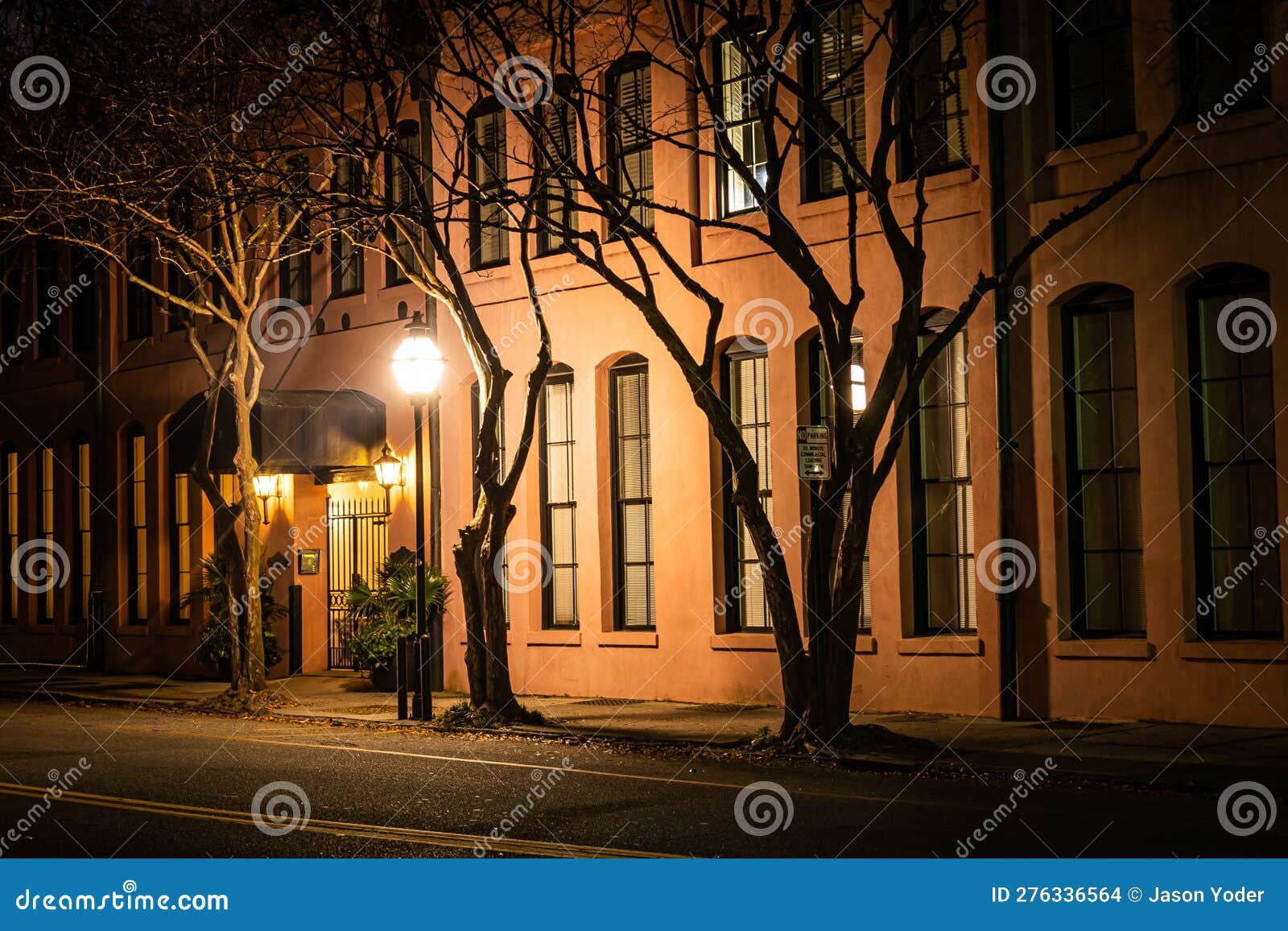 The Side of a Brick Building Lit Up at Night Giving it a Haunted ...