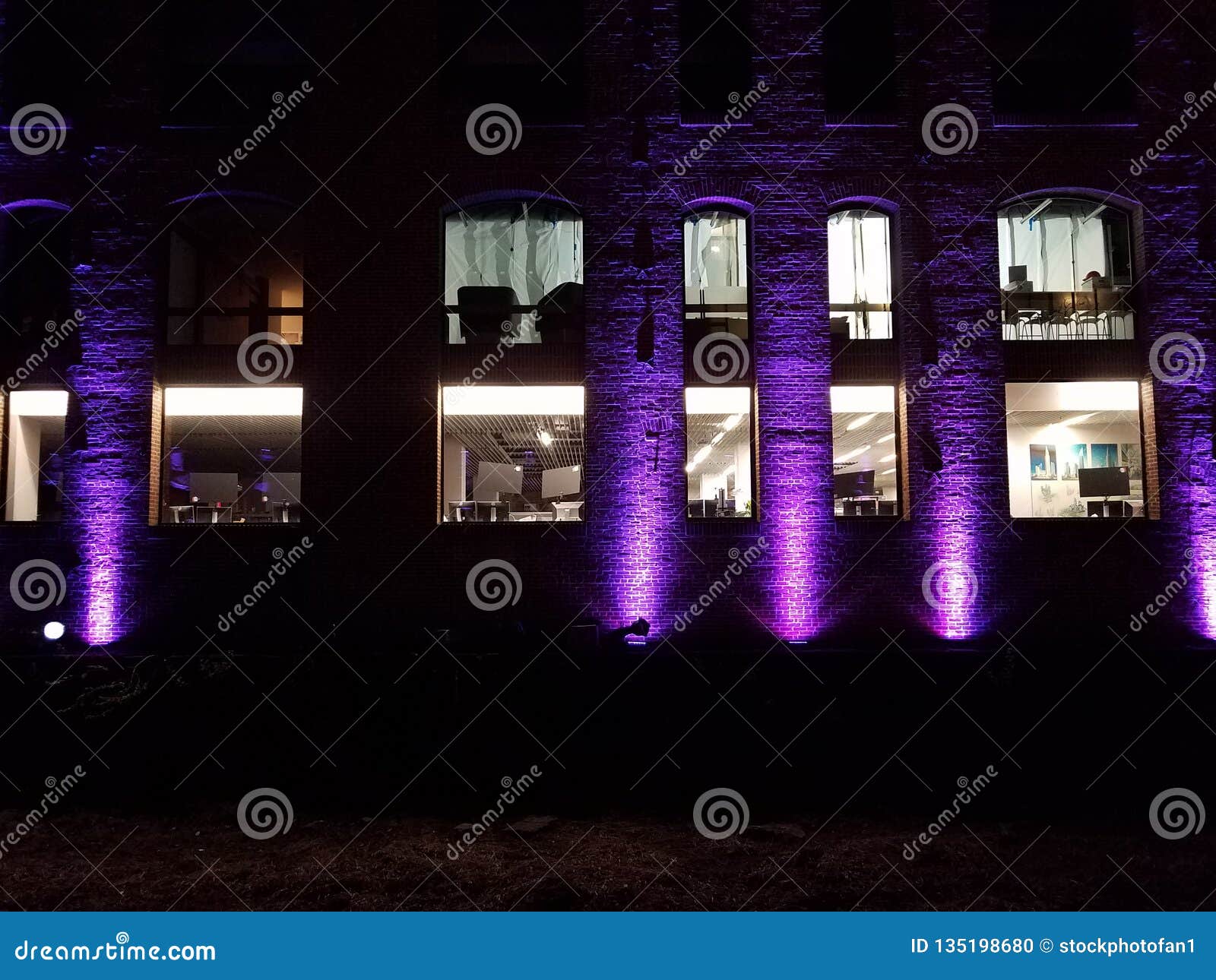 Side of Brick Building with Purple Lights Stock Photo - Image of dark ...