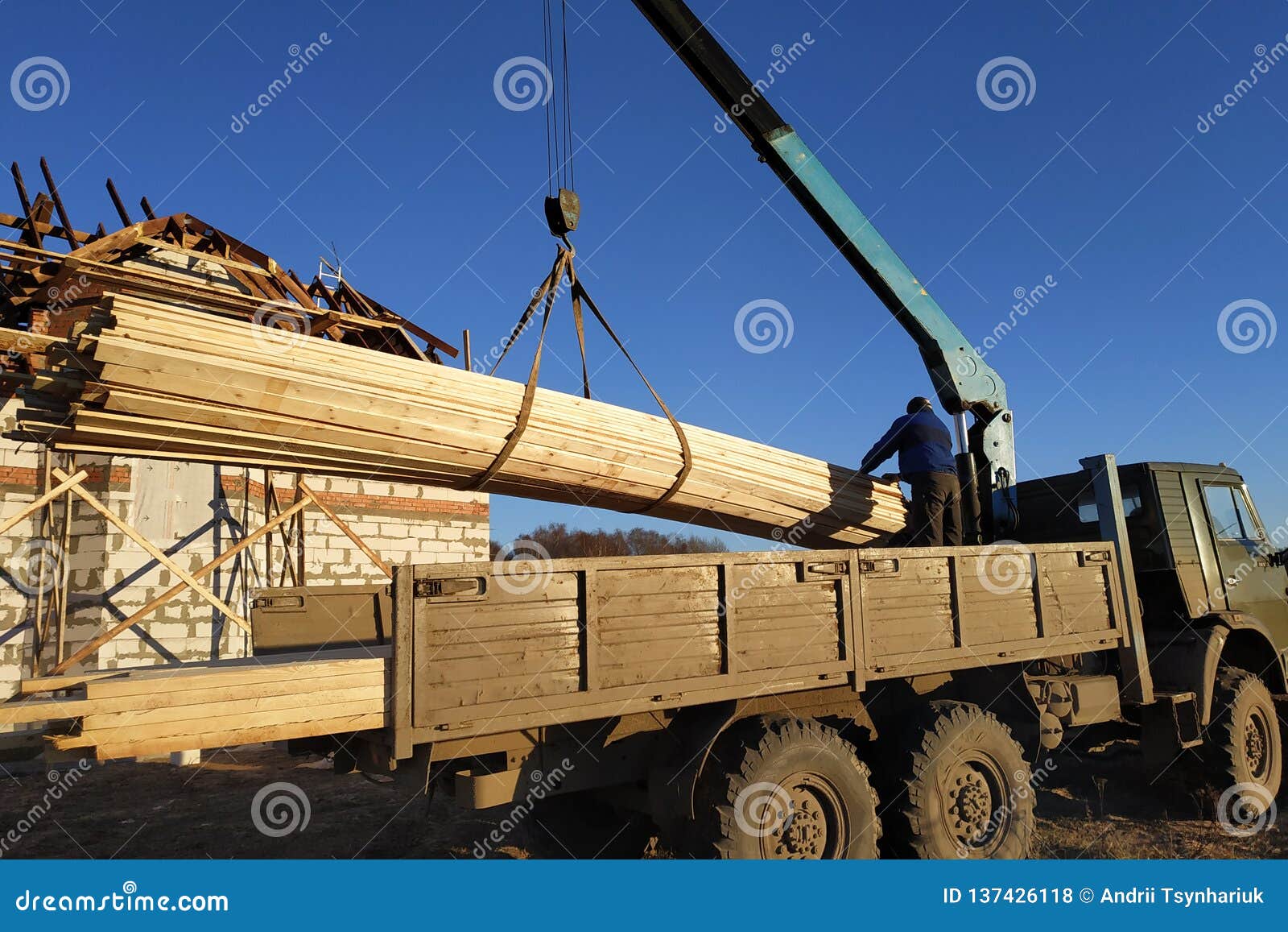 From the Side of the Cargo Crane Unload the Boards for the Construction ...