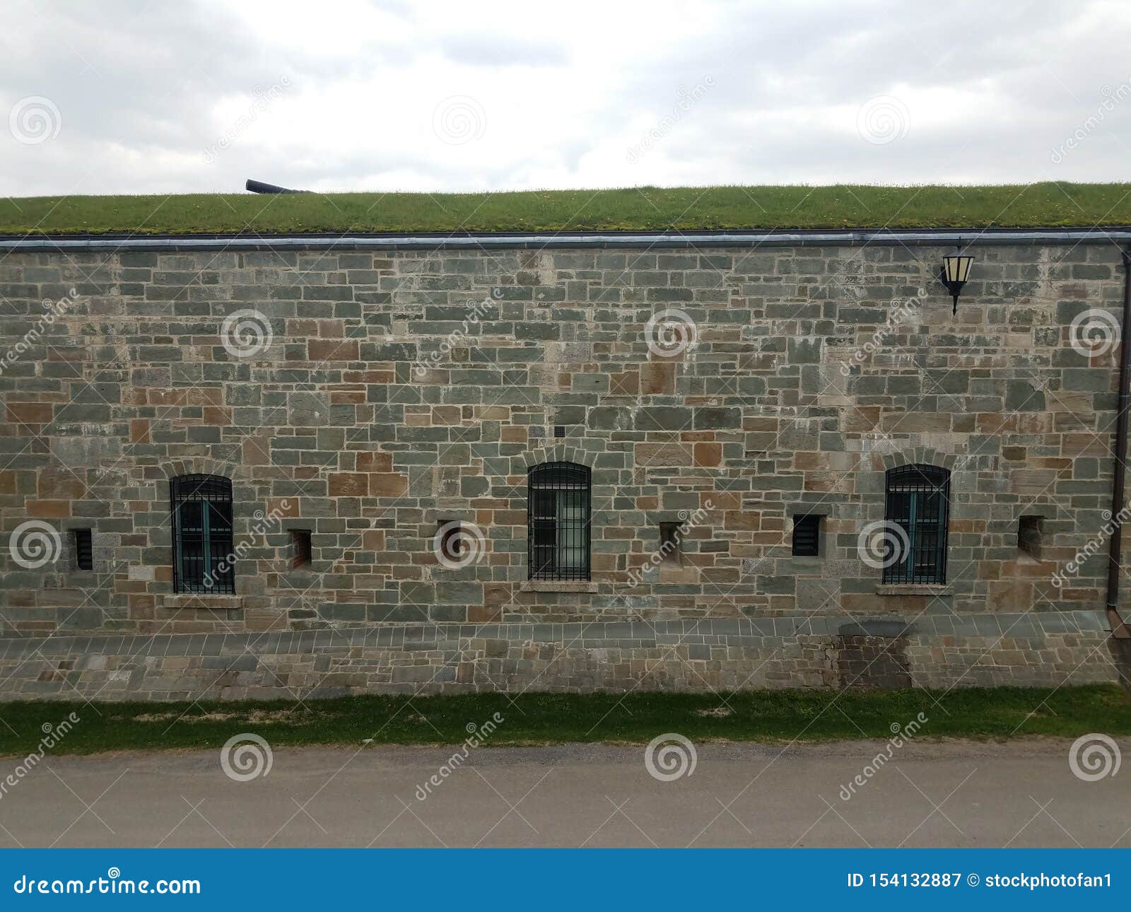 Side of a Castle Wall with Stones and Windows and Grass Stock Image ...