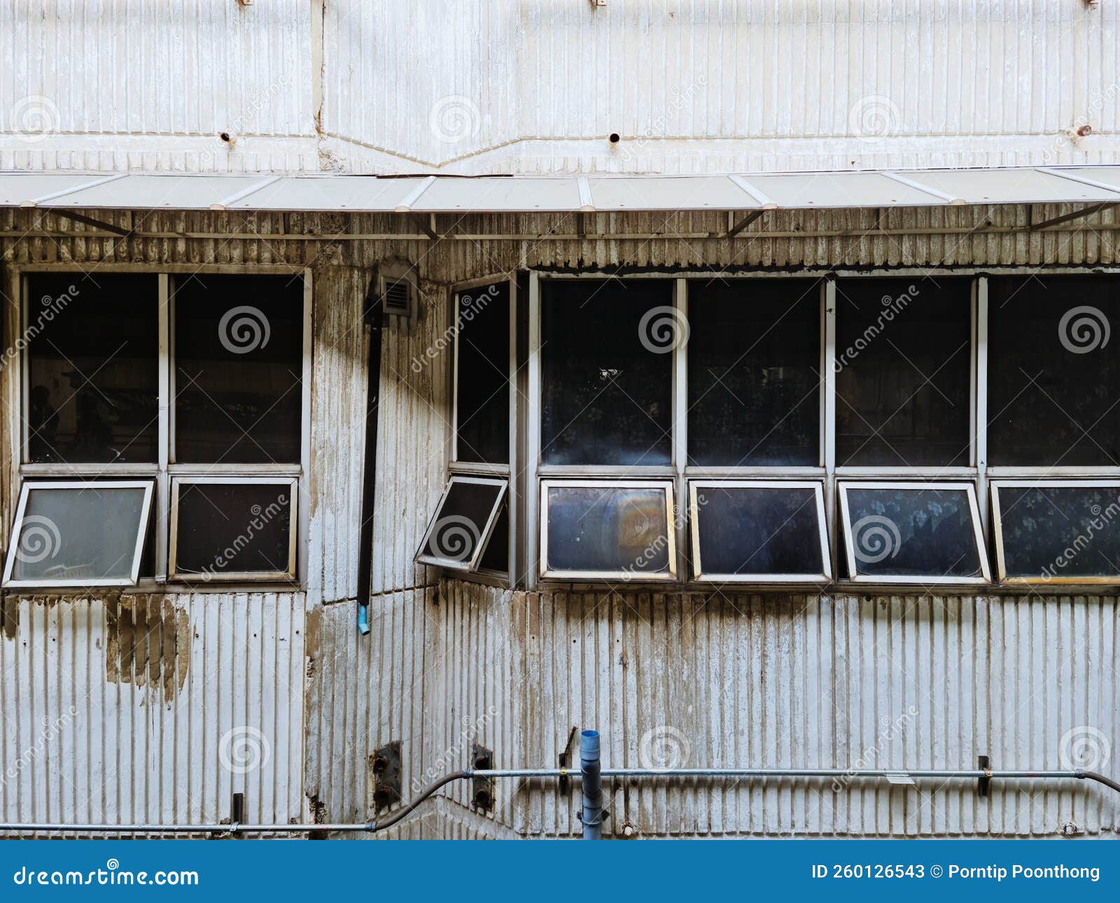 Side of Concrete Building, There are Windows and Pipes. Stock Image ...