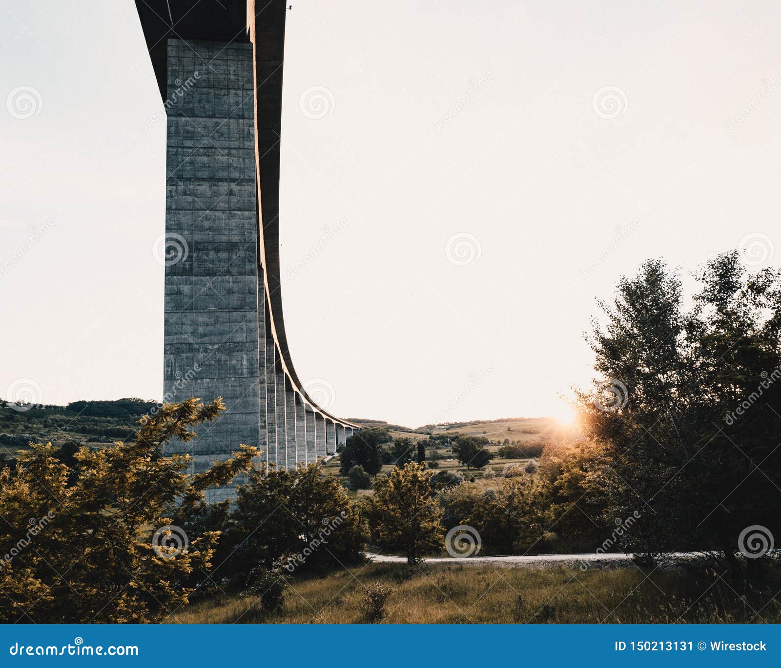 Side of a High Stone Highway Bridge with Clear White Sky in the ...