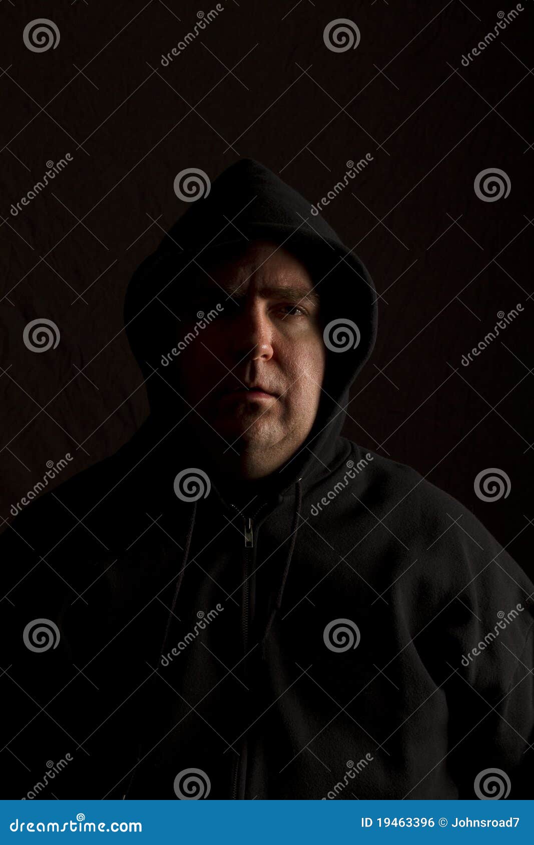 Side-lit Man Hood stock photo. Image of face, concept - 19463396