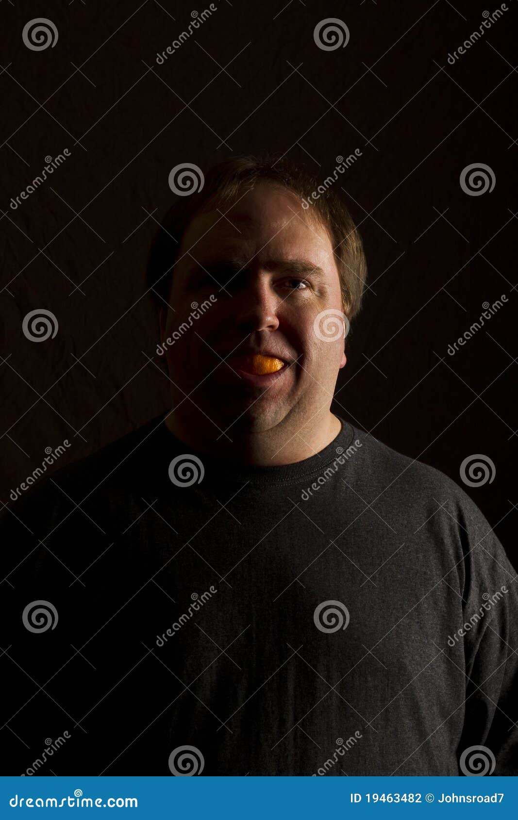 Side-lit Man Orange stock photo. Image of face, white - 19463482