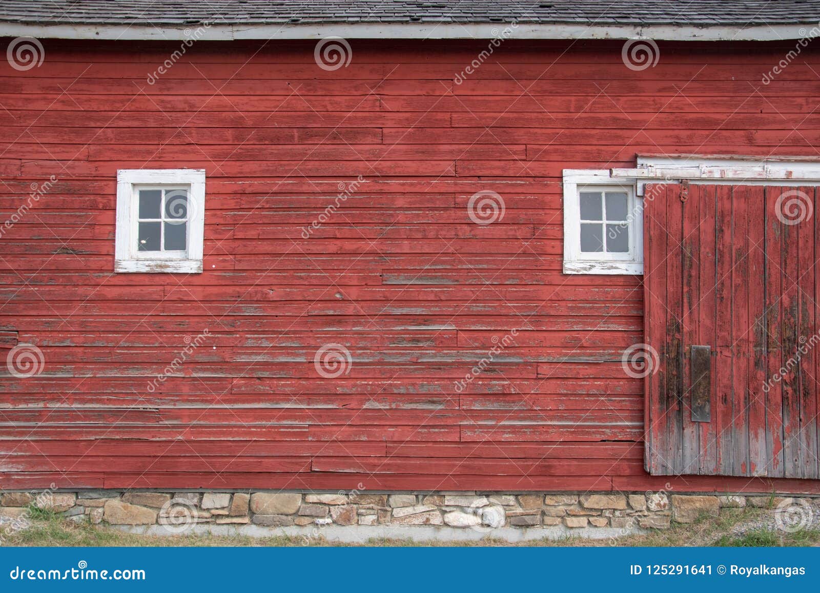 Side of an Old Red Barn with White Framed Square Windows and Sliding ...