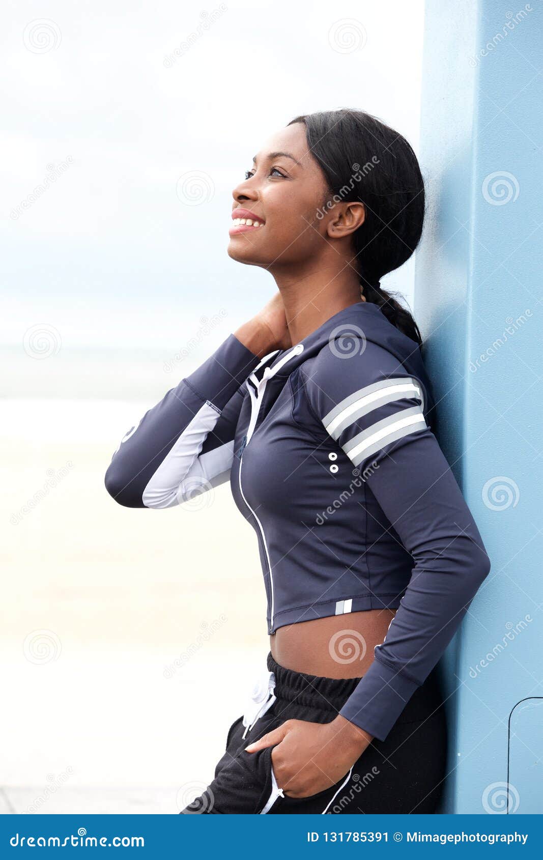 Smiling Young Black Woman Leaning Against Wall Outside Stock Image ... Smiling Young Black Woman Leaning Against Wall Outside Stock Image ...