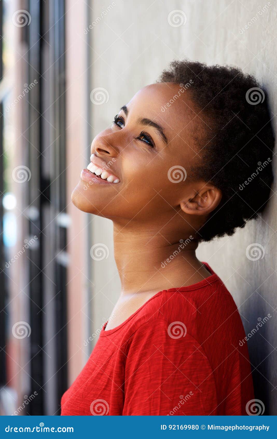 Side Portrait of Young Woman Smiling and Looking Up Stock Photo - Image ...