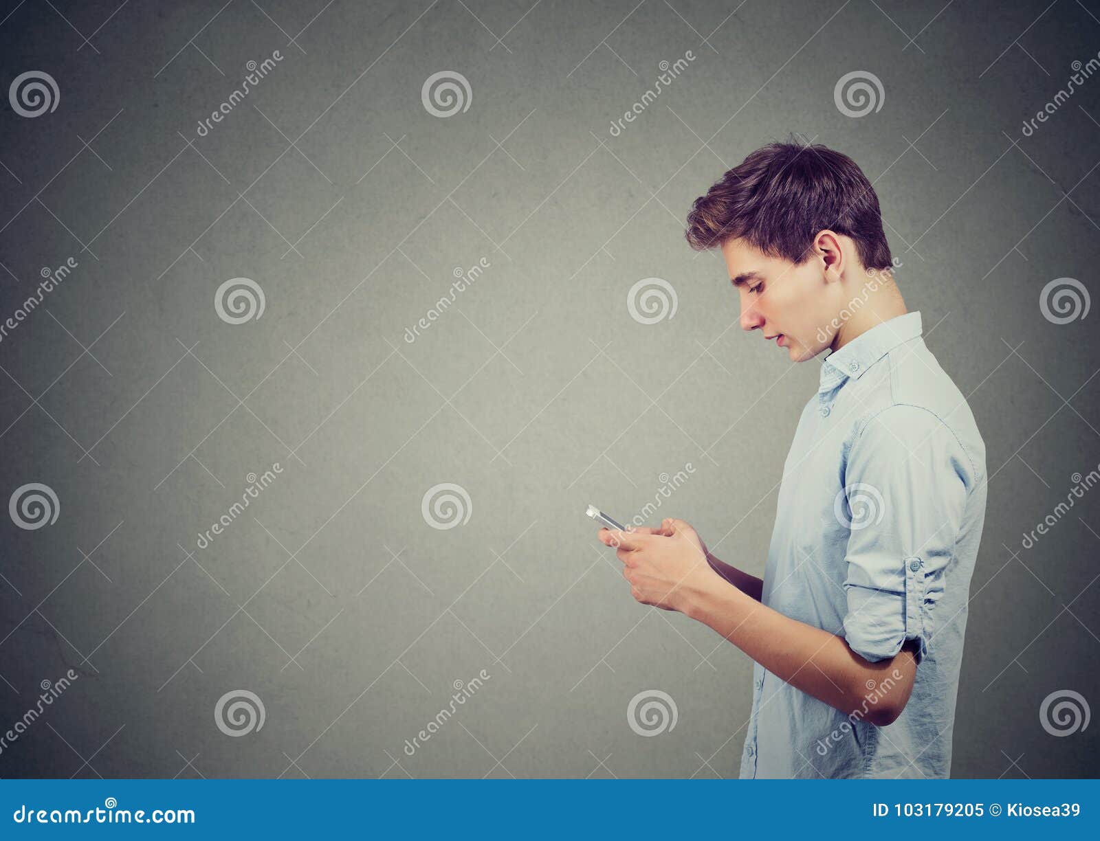 Side Profile of a Handsome Young Guy Using a Smartphone Stock Image ...